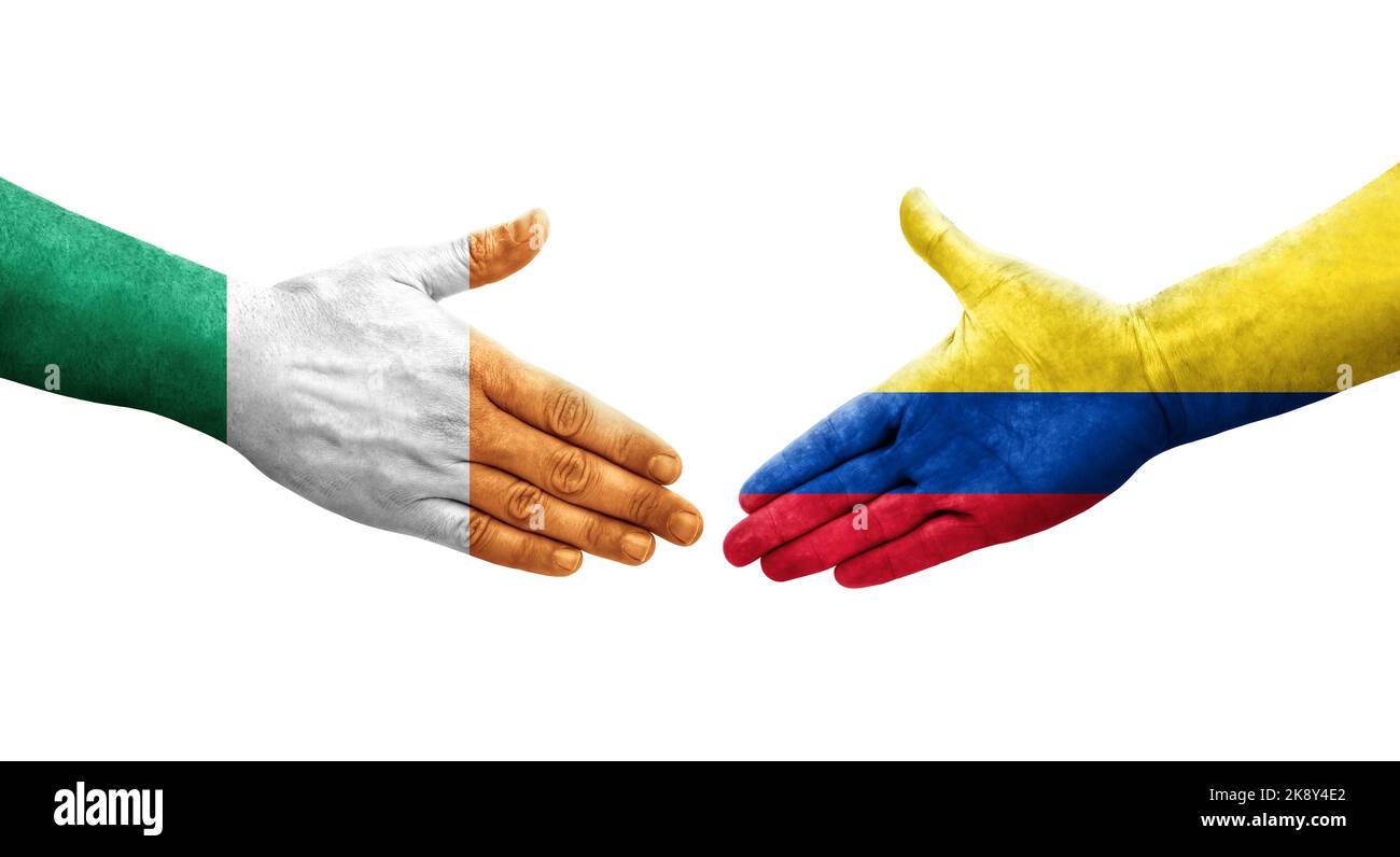 Handshake between Colombia and Ireland flags painted on hands, isolated ...