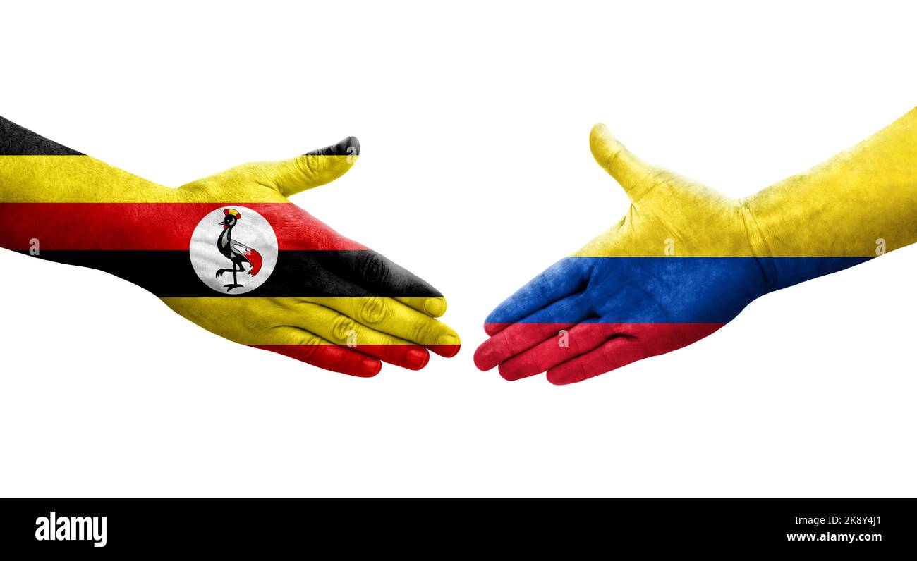 Handshake between Colombia and Uganda flags painted on hands, isolated ...