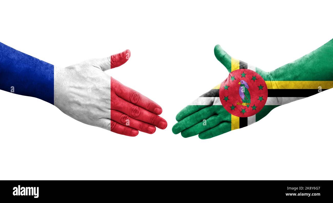 Handshake between Dominica and France flags painted on hands, isolated ...