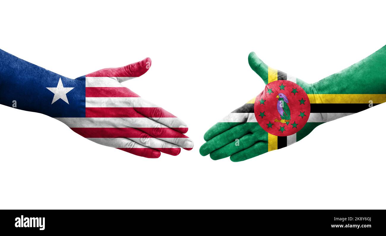 Handshake between Dominica and Liberia flags painted on hands, isolated ...