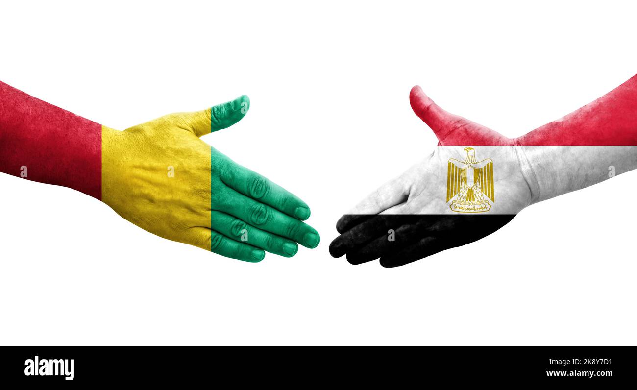 Handshake between Egypt and Guinea flags painted on hands, isolated ...
