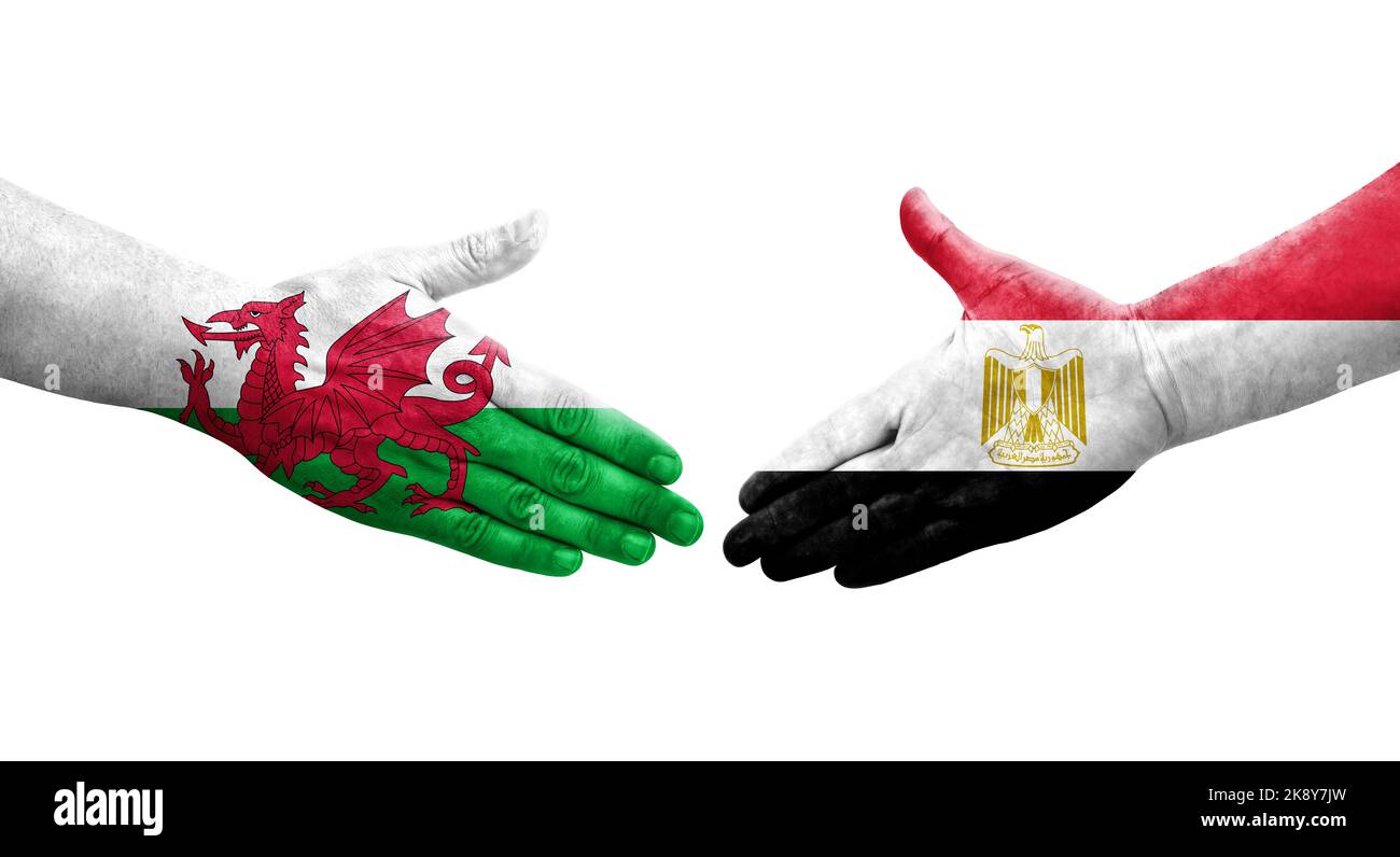Handshake between Egypt and Wales flags painted on hands, isolated ...