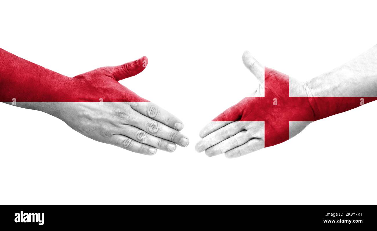 Handshake between England and Monaco flags painted on hands, isolated ...