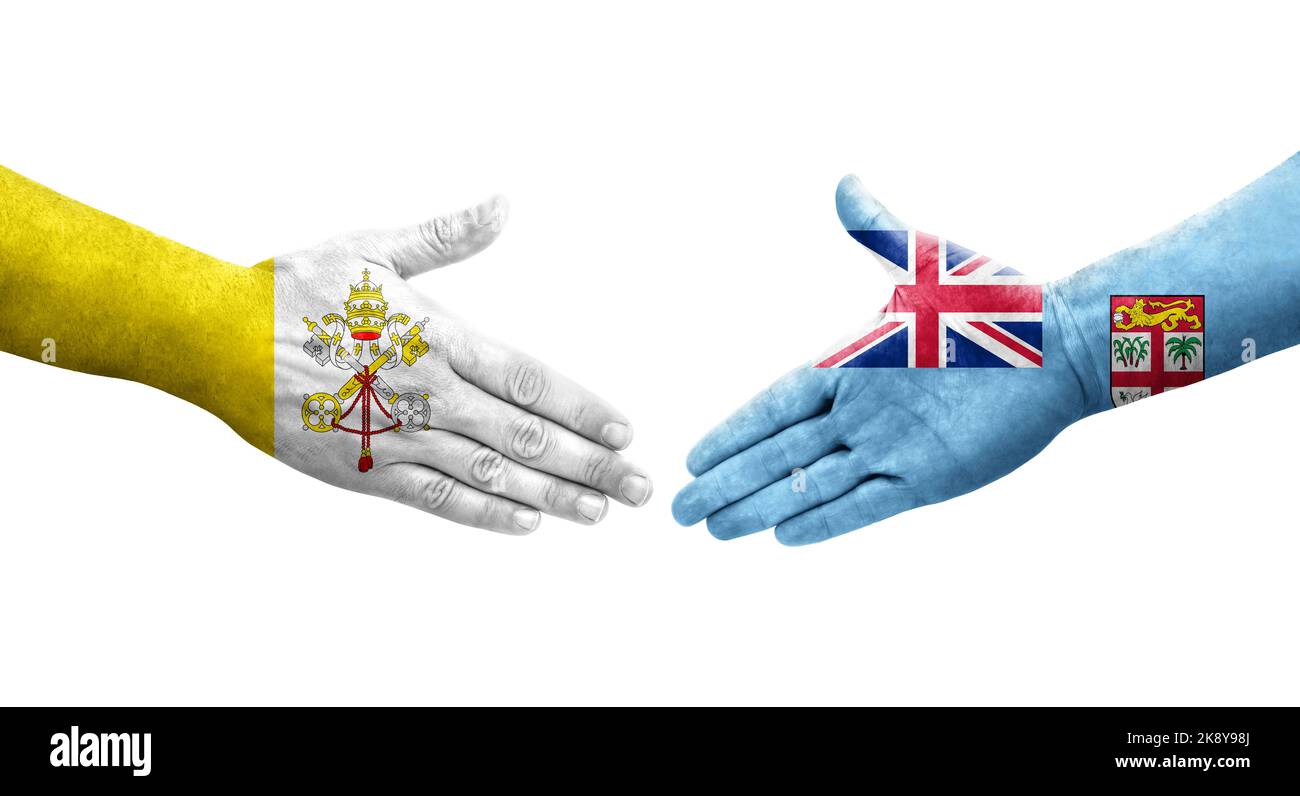 Handshake between Fiji and Holy See flags painted on hands, isolated ...