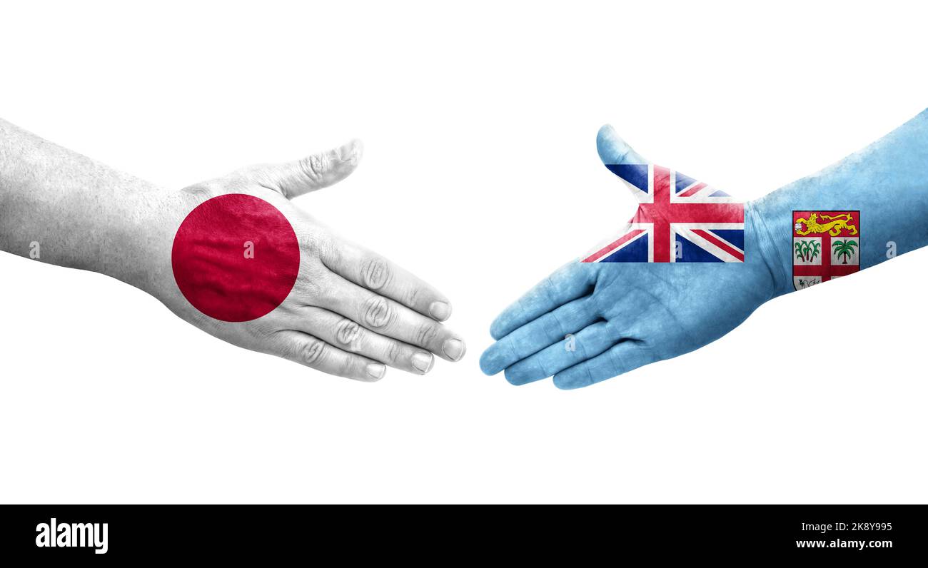 Handshake between Fiji and Japan flags painted on hands, isolated ...