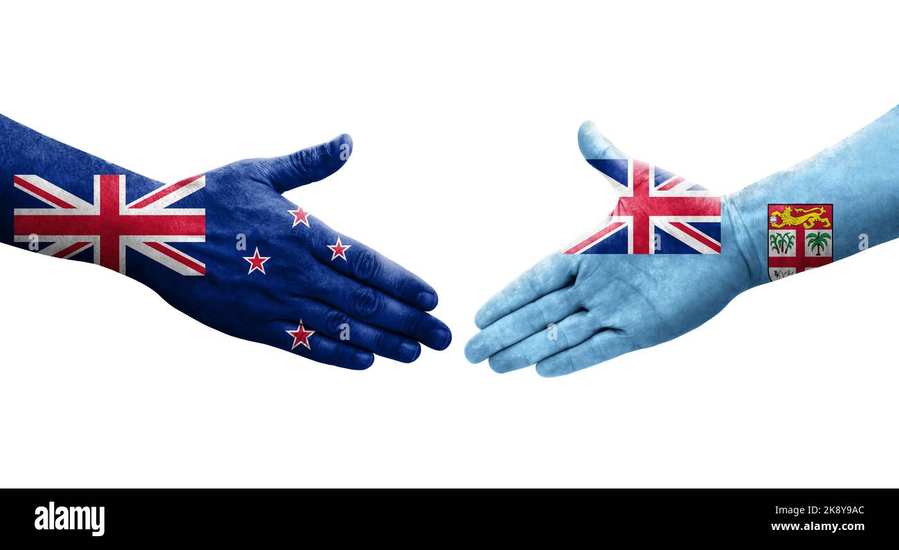 Handshake between Fiji and New Zealand flags painted on hands, isolated ...