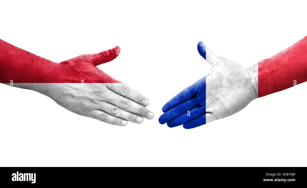 Handshake between France and Monaco flags painted on hands, isolated ...