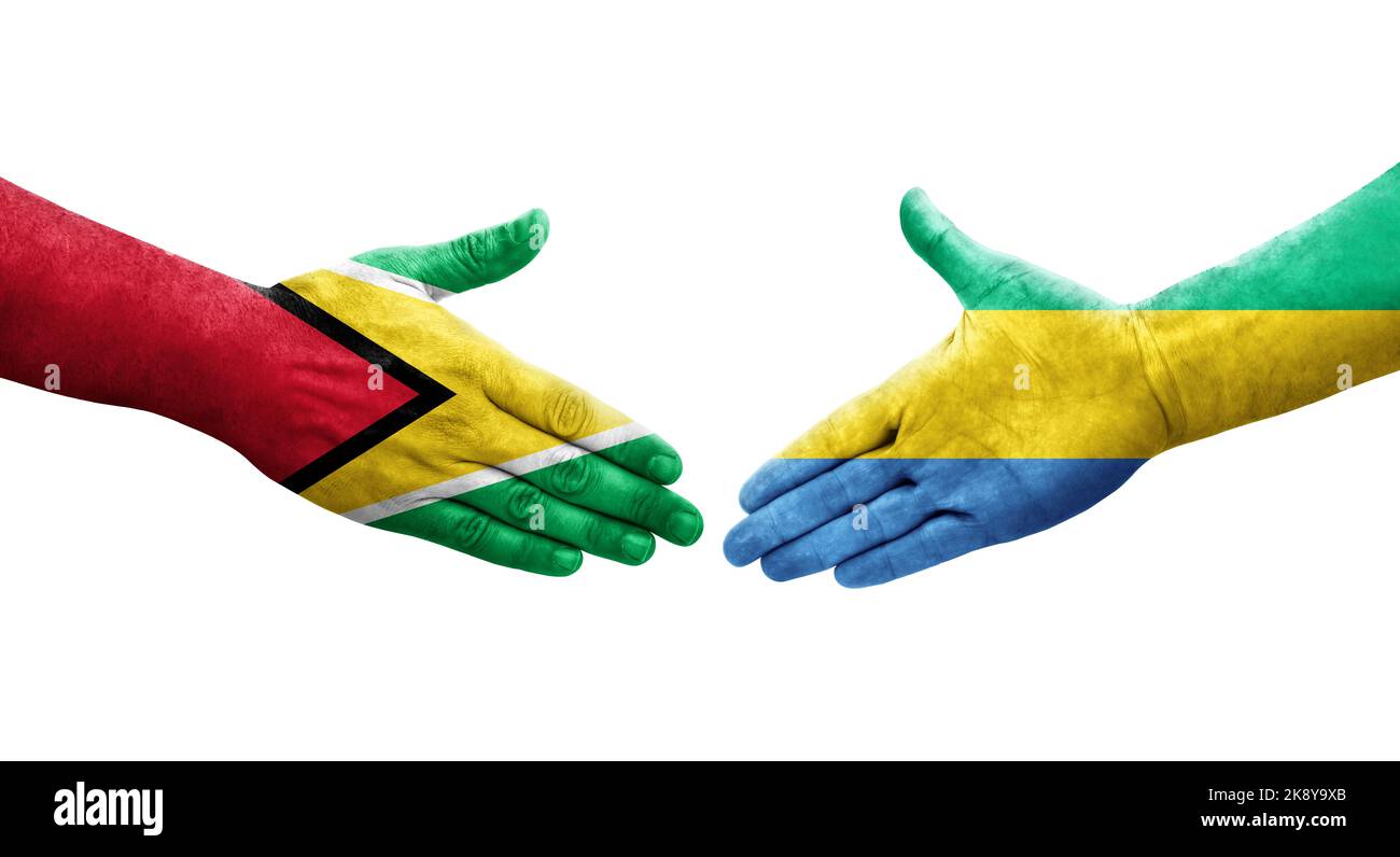 Handshake between Gabon and Guyana flags painted on hands, isolated ...