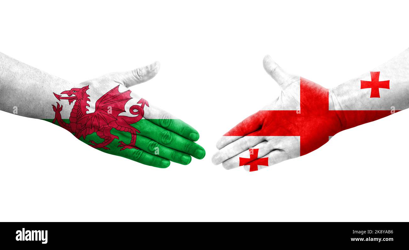 Handshake between Georgia and Wales flags painted on hands, isolated ...