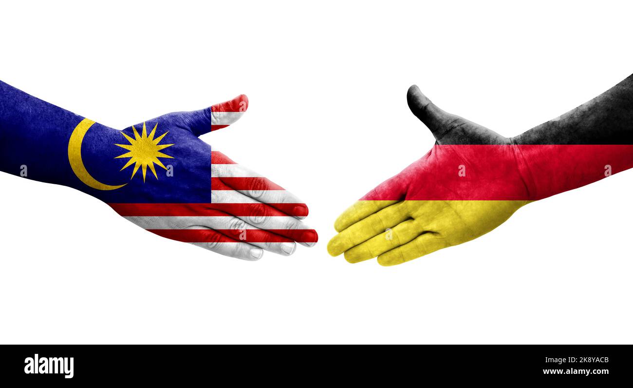 Handshake between Germany and Malaysia flags painted on hands, isolated ...