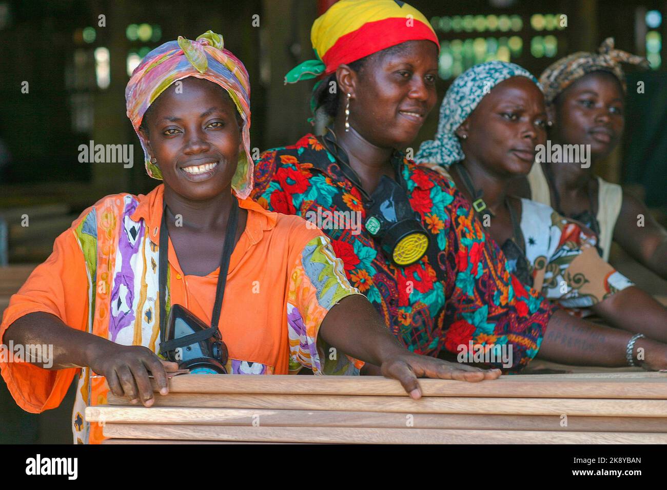 Ghana, Takoradi. Female workers of timber company sandpaper wood. The ...