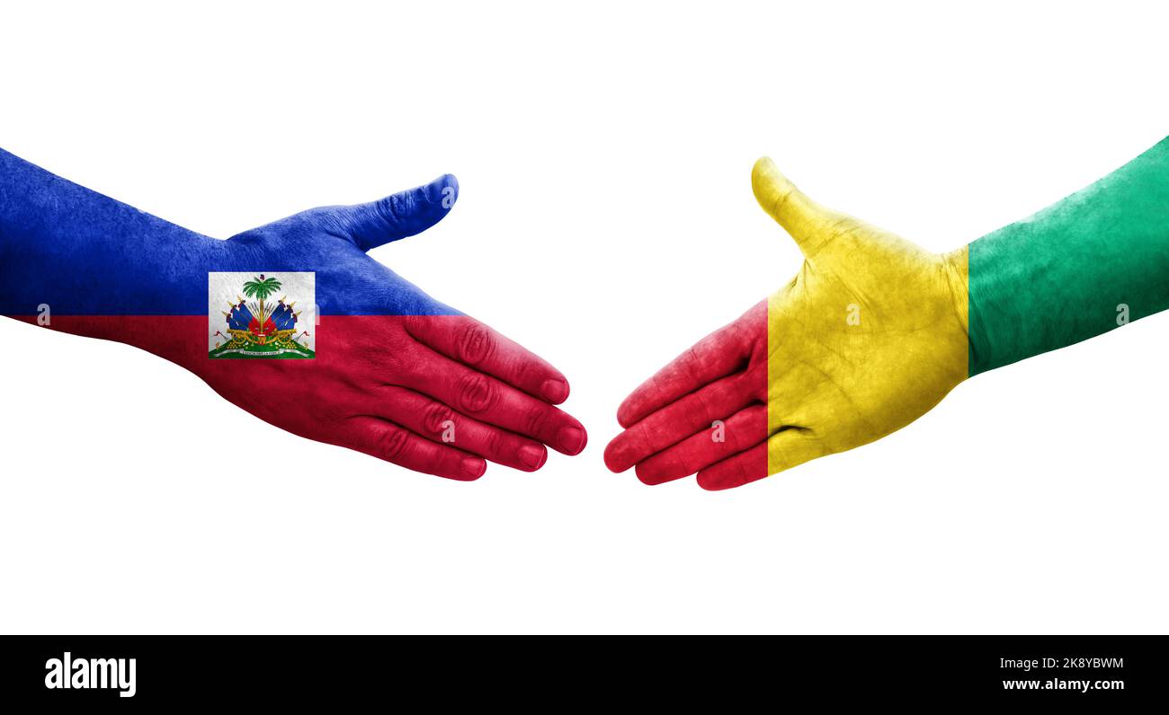 Handshake between Guinea and Haiti flags painted on hands, isolated ...
