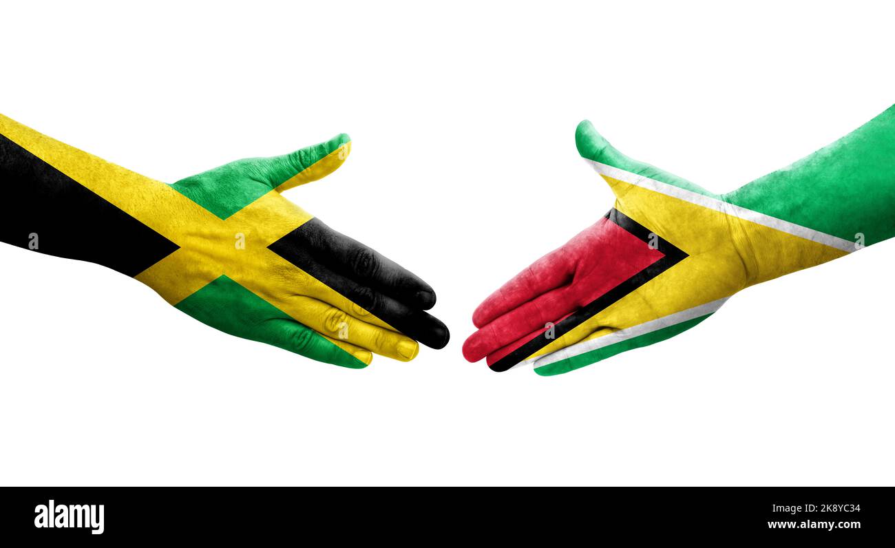 Handshake between Guyana and Jamaica flags painted on hands, isolated ...