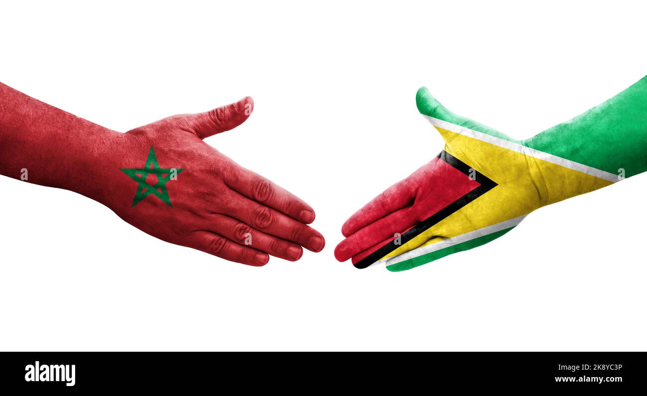Handshake between Guyana and Morocco flags painted on hands, isolated ...