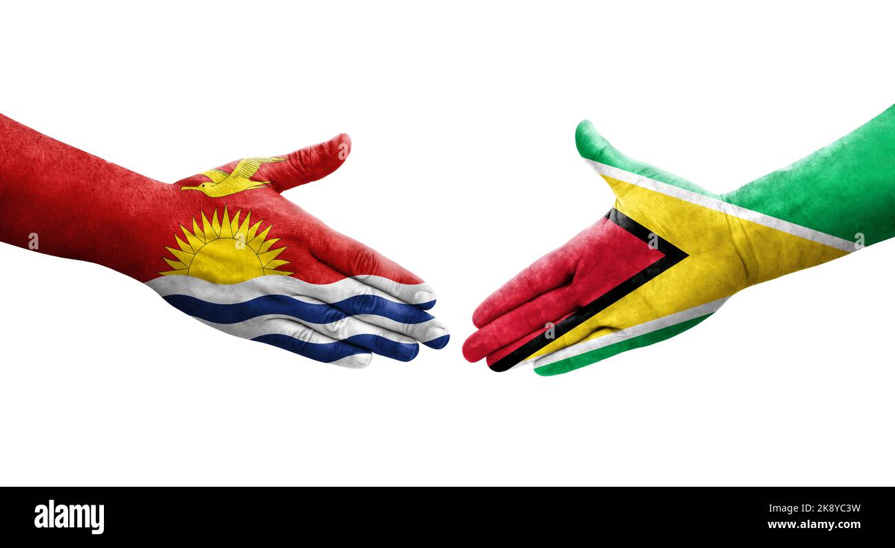 Handshake between Guyana and Kiribati flags painted on hands, isolated ...