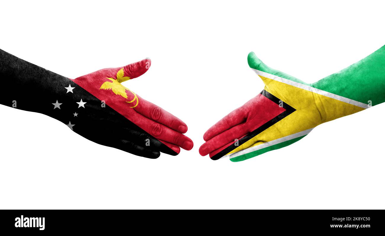 Handshake between Guyana and Papua New Guinea flags painted on hands ...