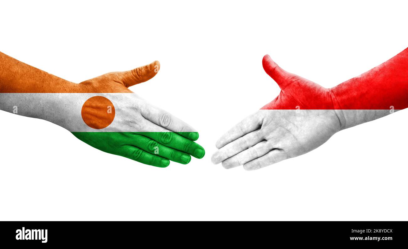 Handshake between Indonesia and Niger flags painted on hands, isolated ...
