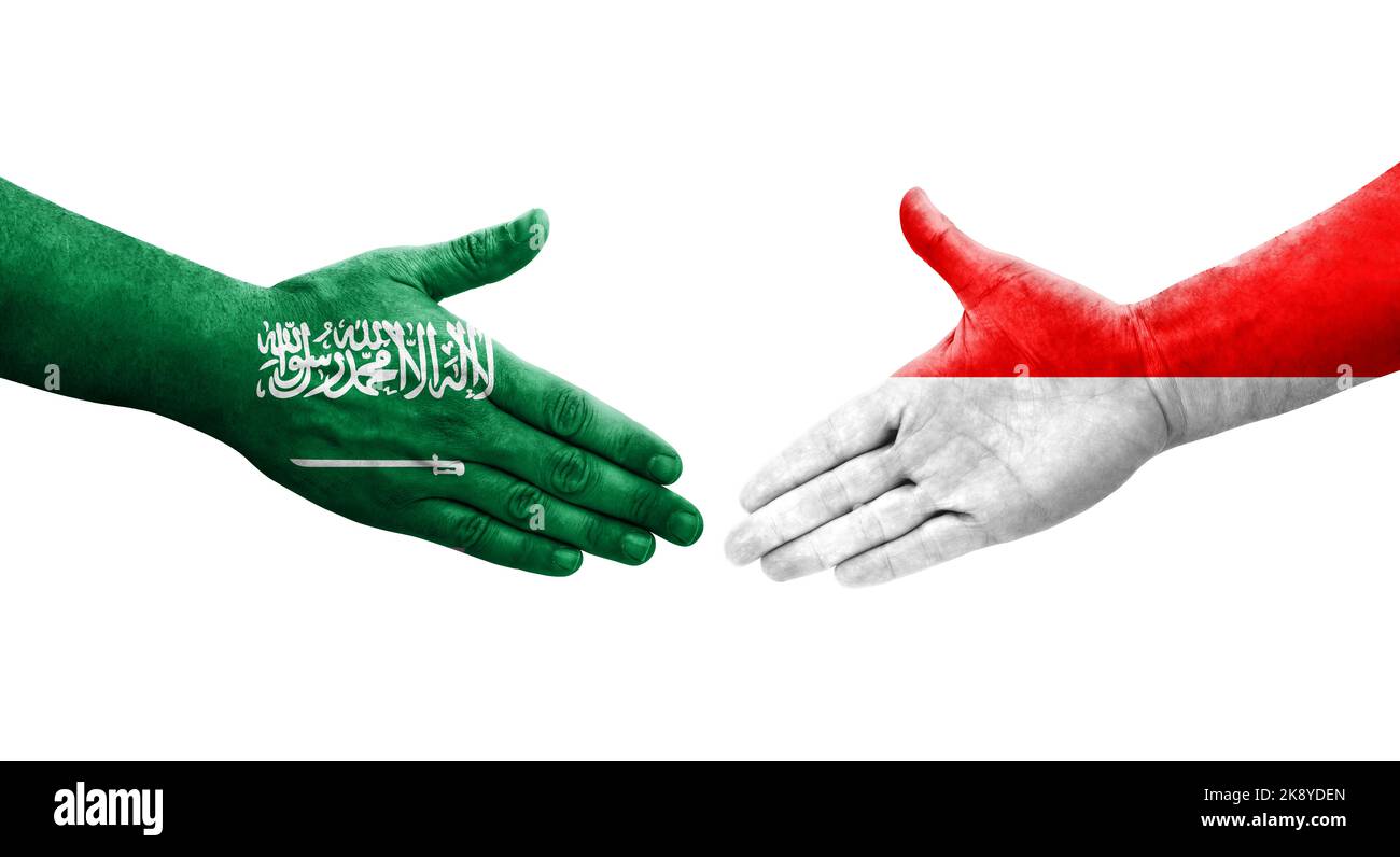 Handshake between Indonesia and Saudi Arabia flags painted on hands ...