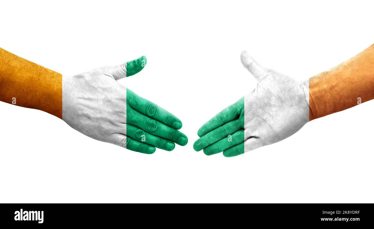 Handshake between Ireland and Ivory Coast flags painted on hands, isolated transparent image ...