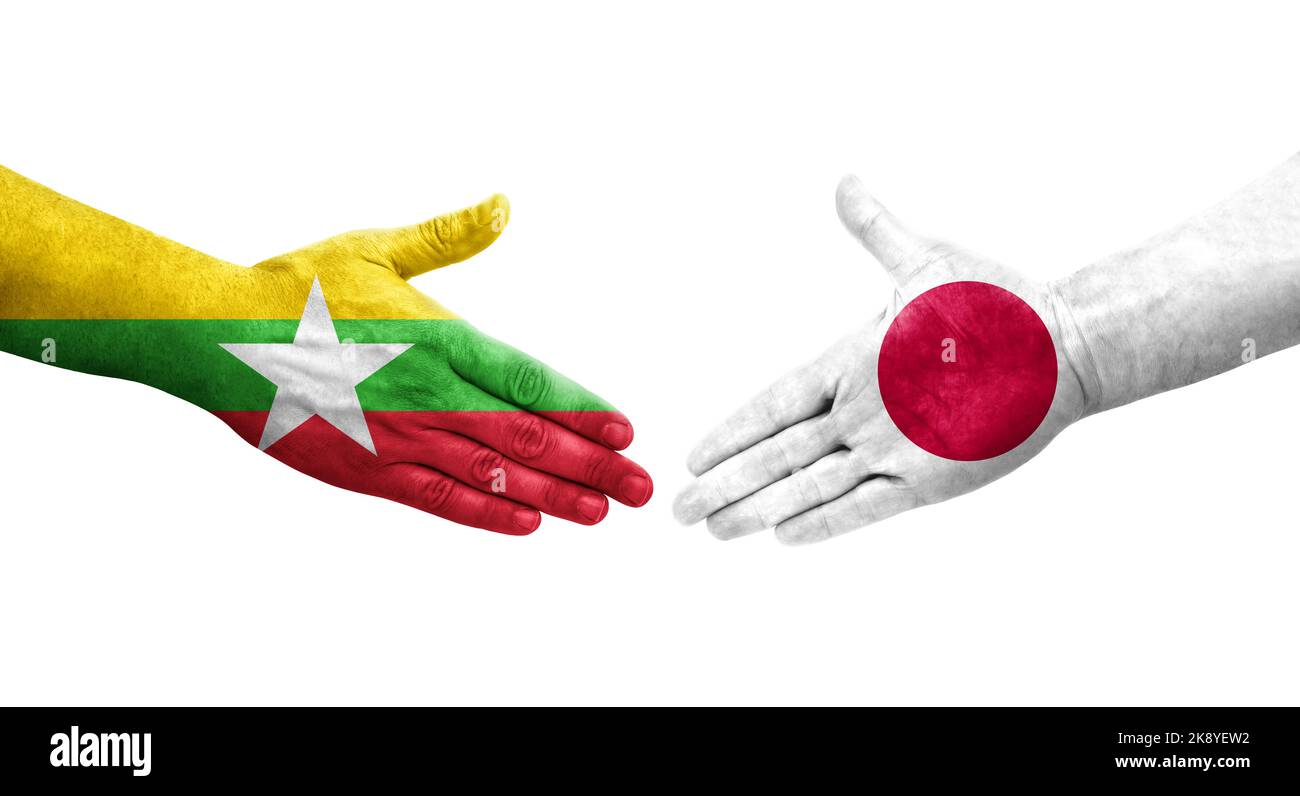 Handshake between Japan and Myanmar flags painted on hands, isolated ...