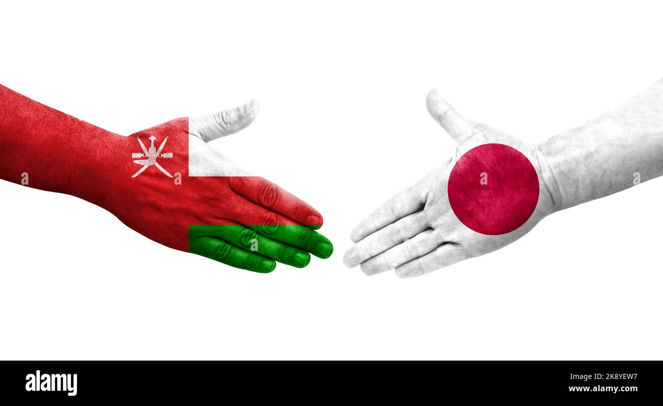 Handshake between Japan and Oman flags painted on hands, isolated transparent image Stock Photo ...