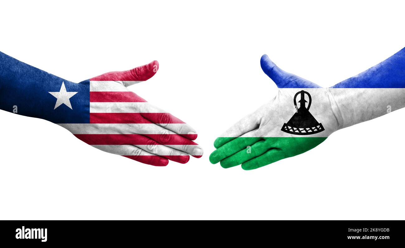 Handshake between Lesotho and Liberia flags painted on hands, isolated ...