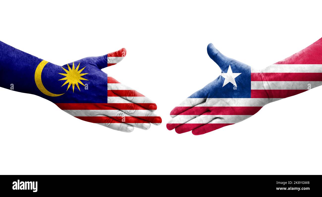 Handshake between Liberia and Malaysia flags painted on hands, isolated ...