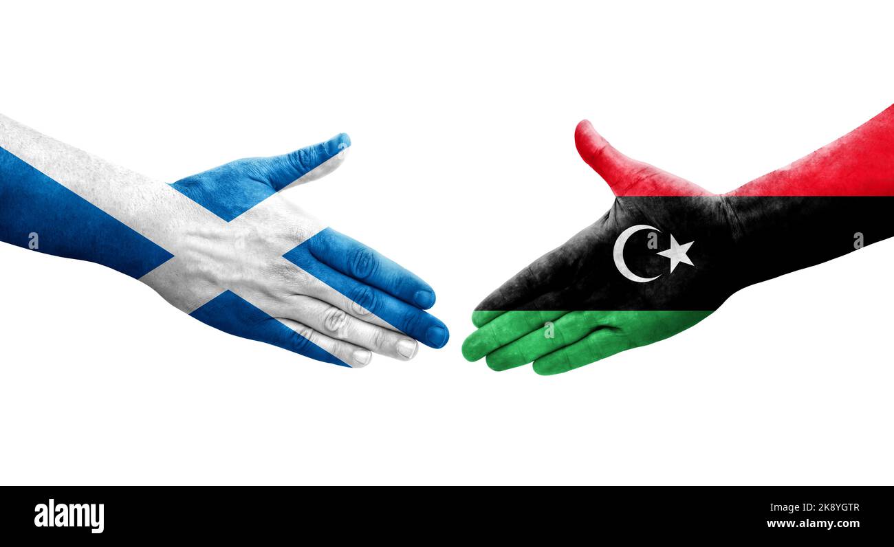 Handshake between Libya and Scotland flags painted on hands, isolated ...