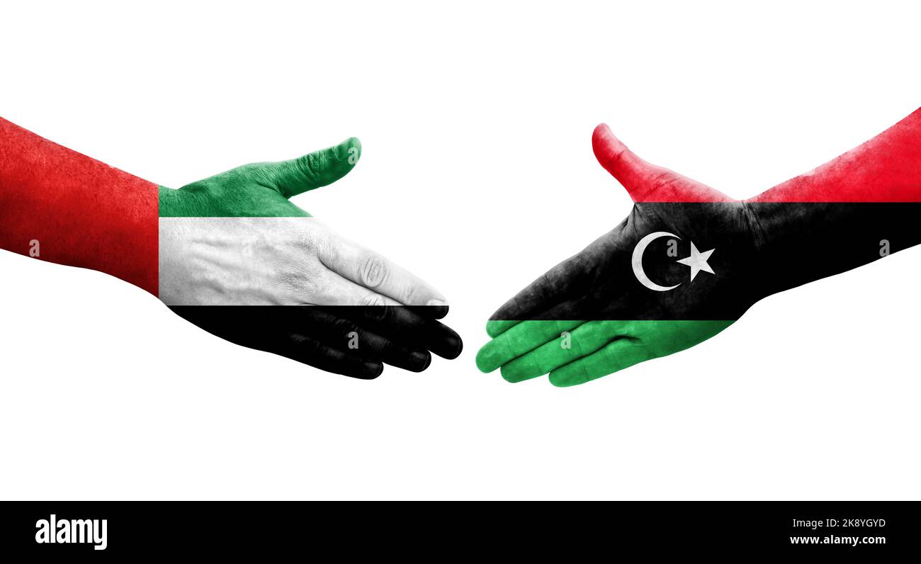 Handshake between Libya and UAE flags painted on hands, isolated ...