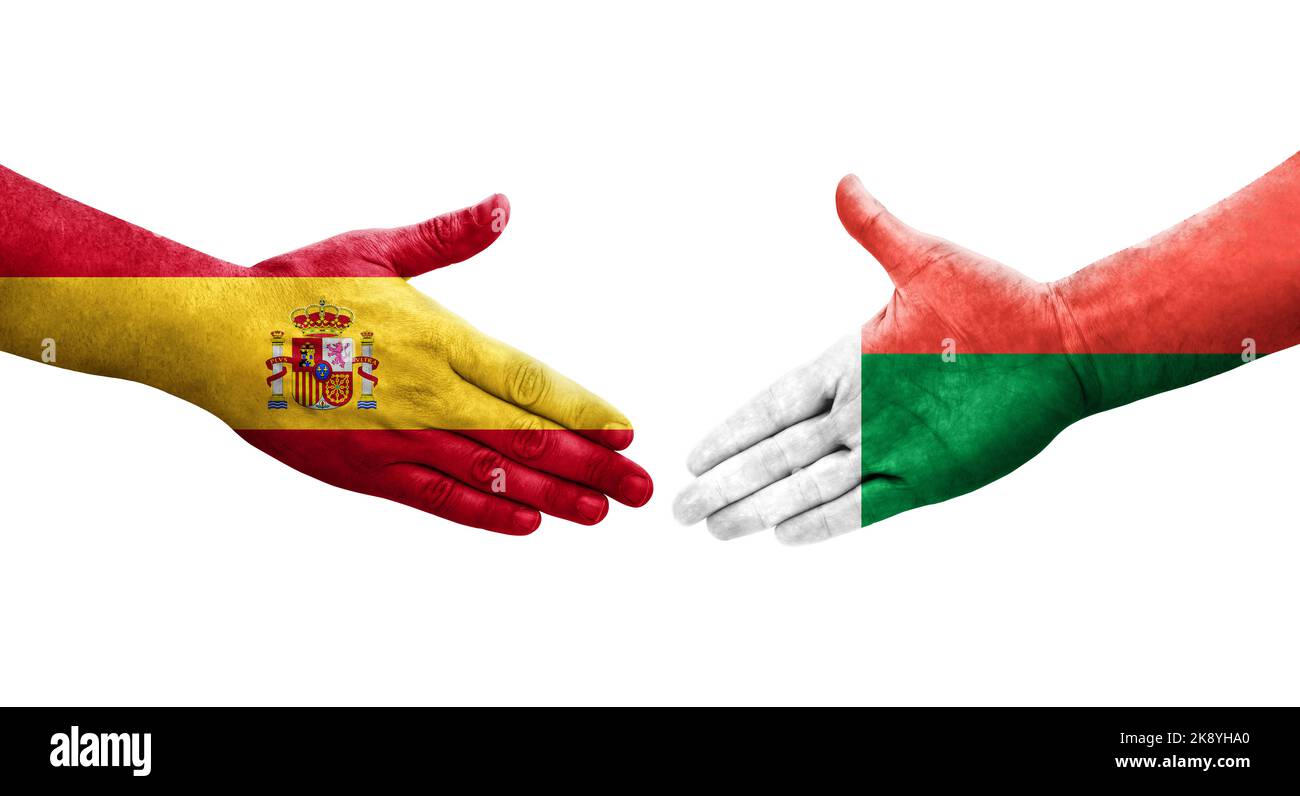 Handshake between Madagascar and Spain flags painted on hands, isolated ...