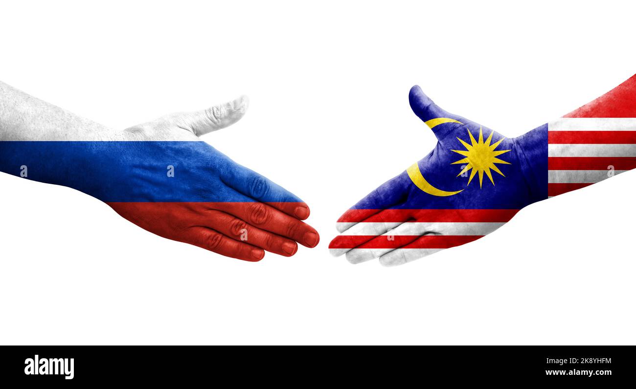 Handshake between Malaysia and Russia flags painted on hands, isolated ...