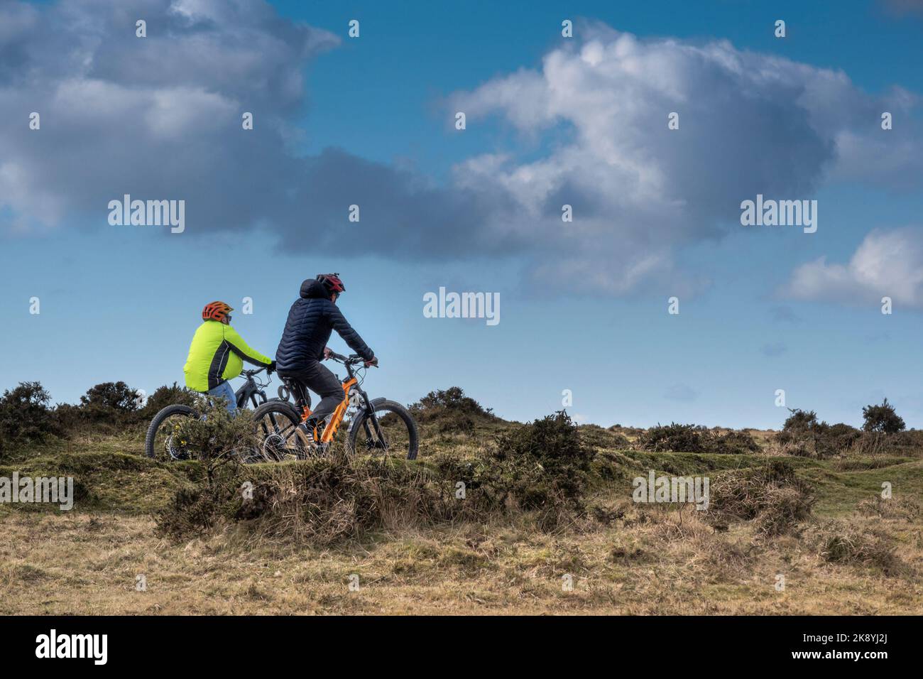 Cyclists cycling on a rough path on the rugged Bodmin Moor in Cornwall ...
