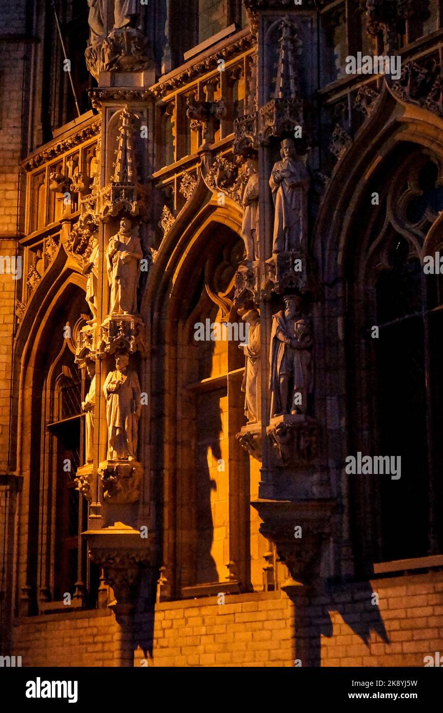 A vertical shot of beautifully sculpted columns and statues in front of ...