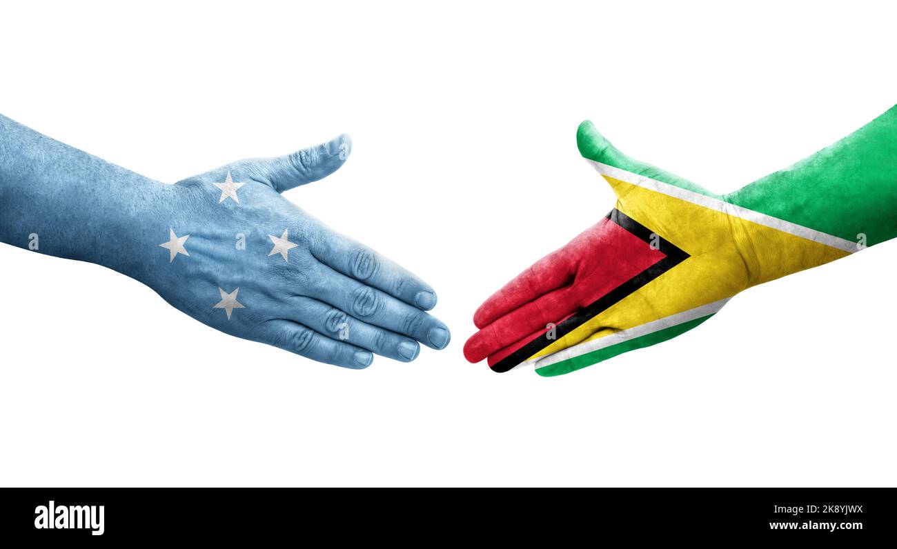 Handshake between Micronesia and Guyana flags painted on hands ...