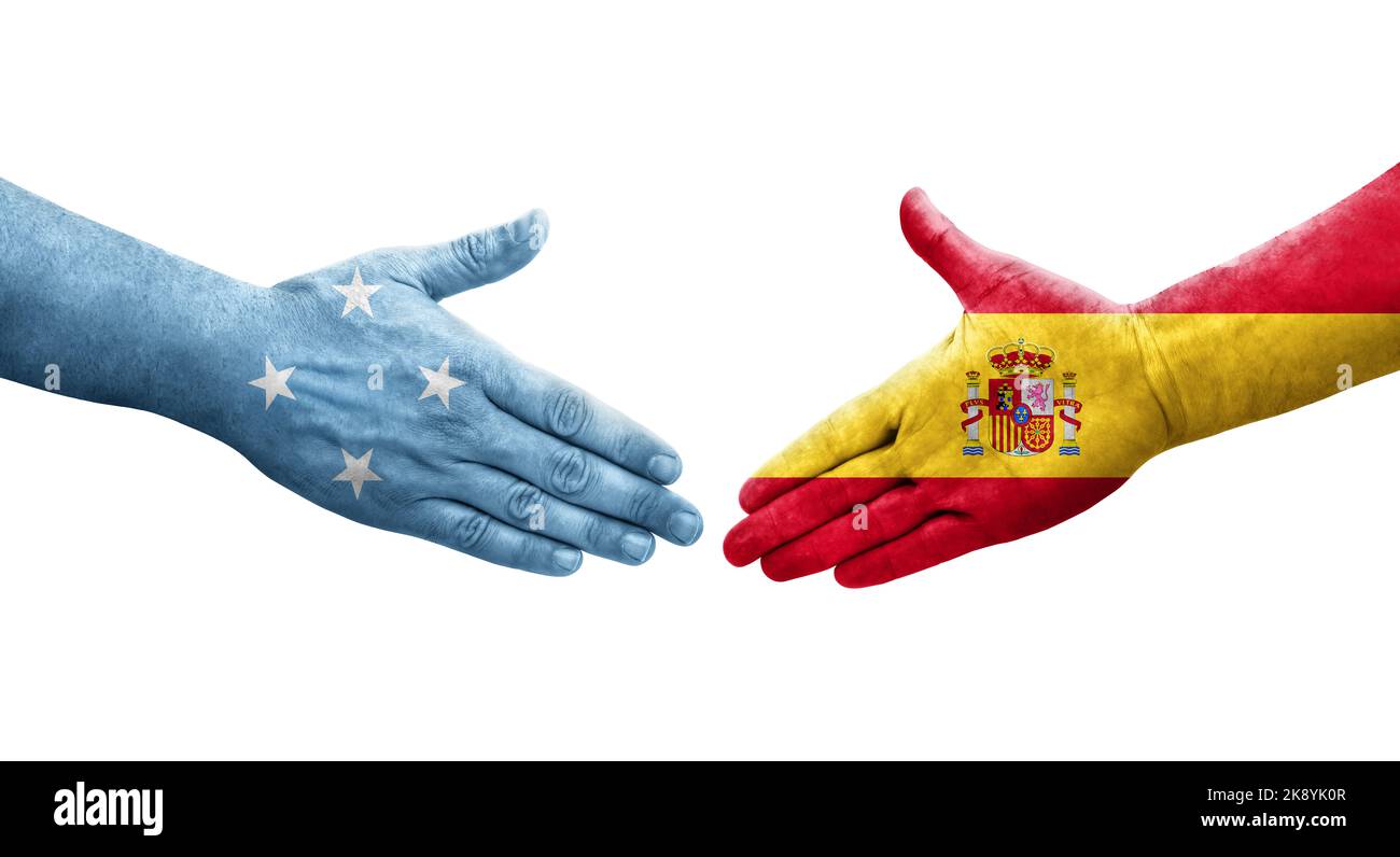 Handshake between Micronesia and Spain flags painted on hands, isolated ...