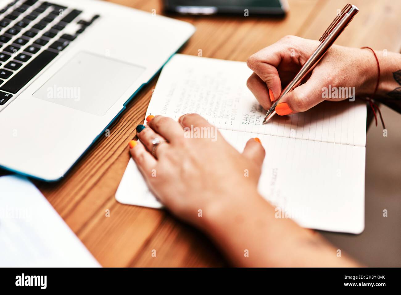 Tracking my expenses. an unrecognizable businesswoman sitting alone and ...
