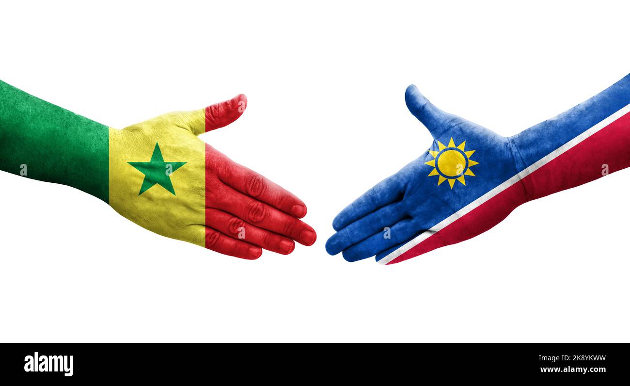 Handshake between Namibia and Senegal flags painted on hands, isolated ...