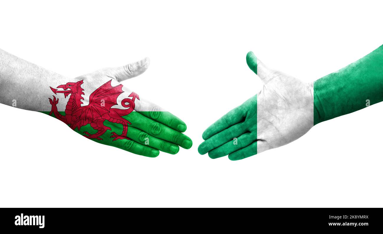 Handshake between Nigeria and Wales flags painted on hands, isolated ...