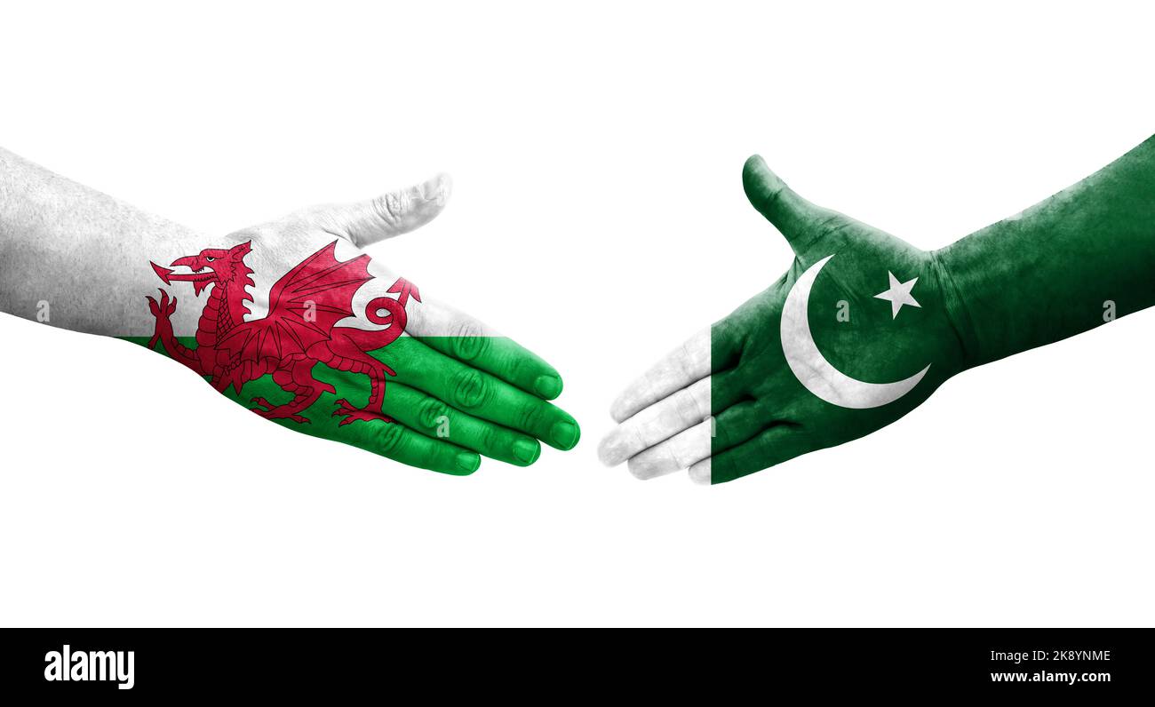 Handshake between Pakistan and Wales flags painted on hands, isolated ...