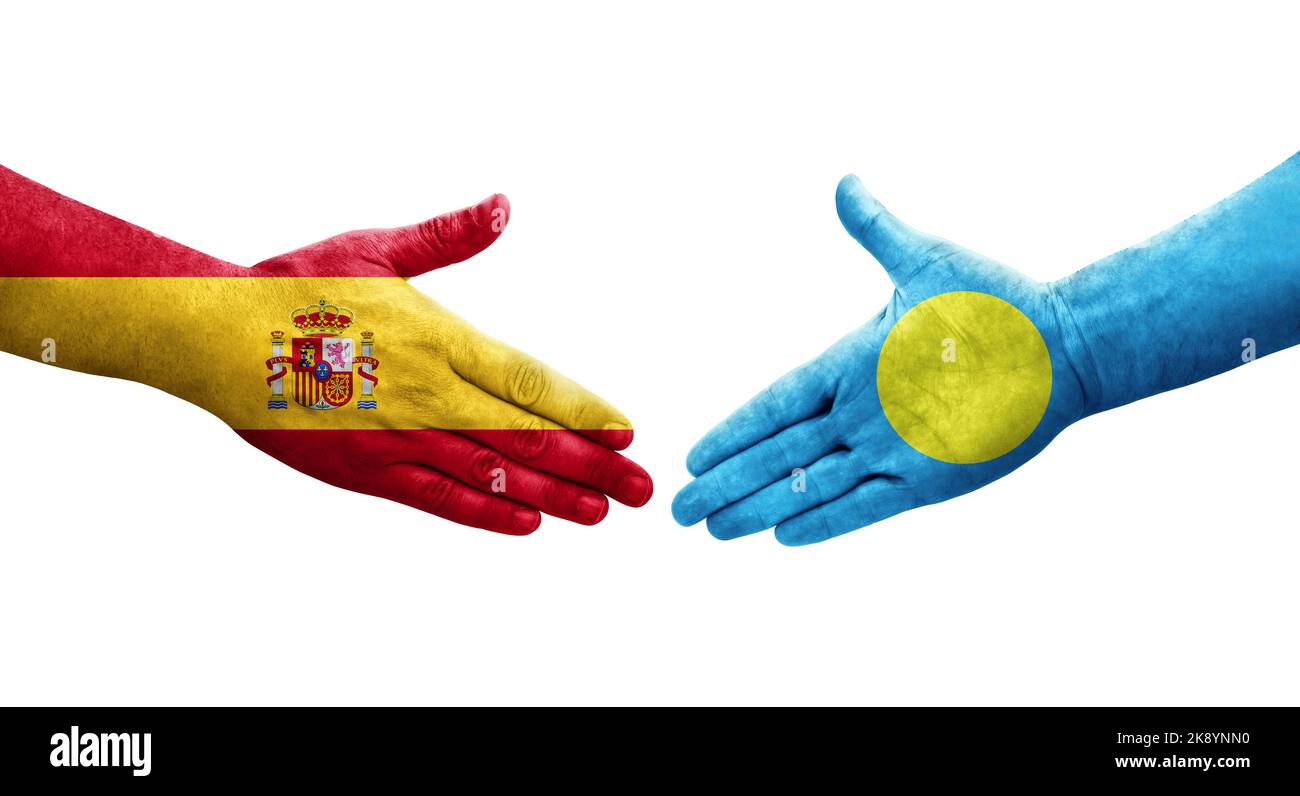 Handshake between Palau and Spain flags painted on hands, isolated ...