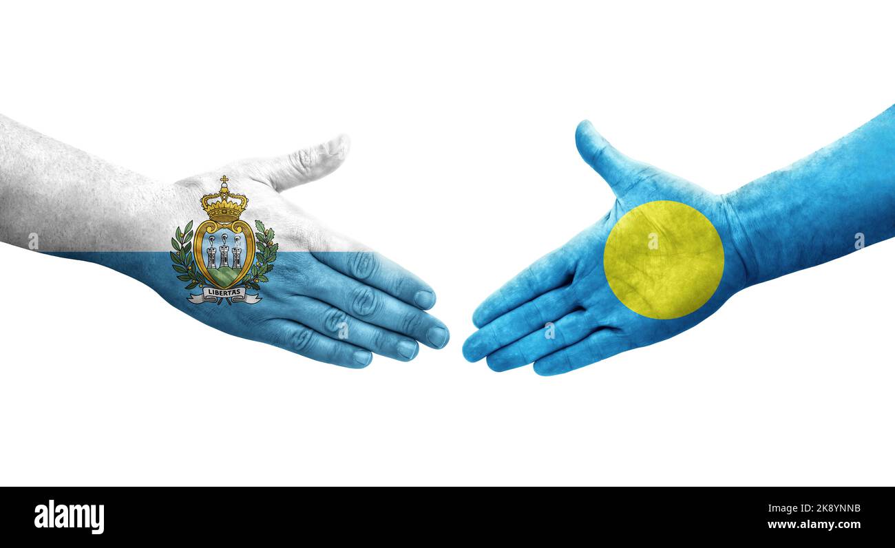 Handshake between Palau and San Marino flags painted on hands, isolated ...