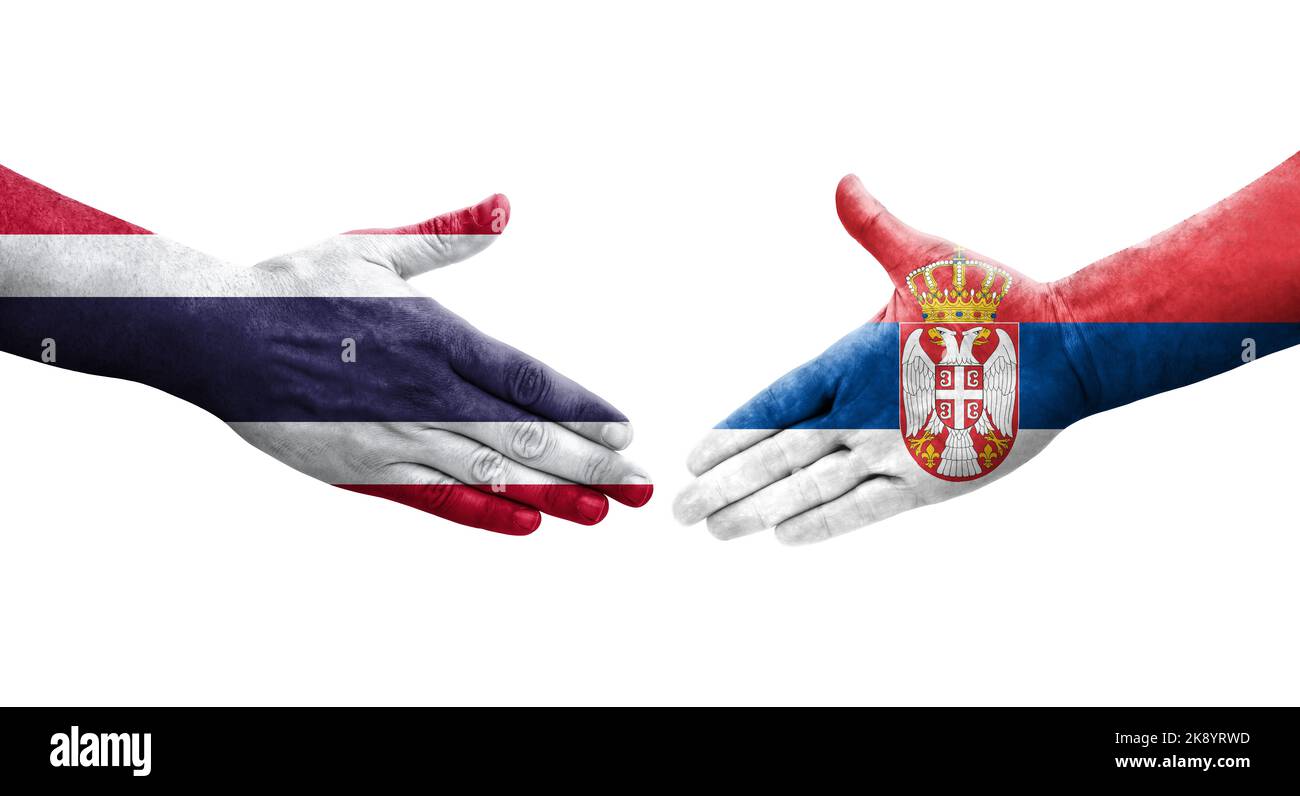Handshake between Serbia and Thailand flags painted on hands, isolated ...