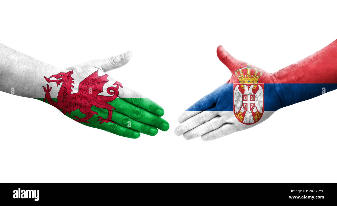 Handshake between Serbia and Wales flags painted on hands, isolated ...