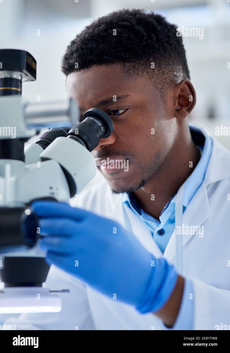 There is so much to see here. a focused young male scientist looking at ...