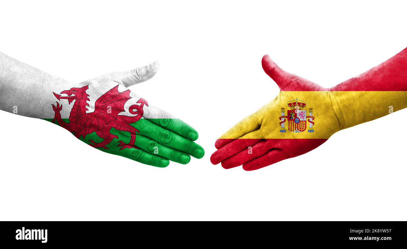 Handshake between Spain and Wales flags painted on hands, isolated ...