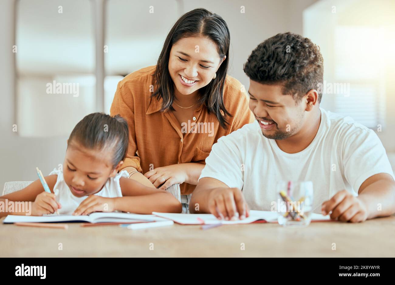 Home, education and parents with chid writing, helping and book ...