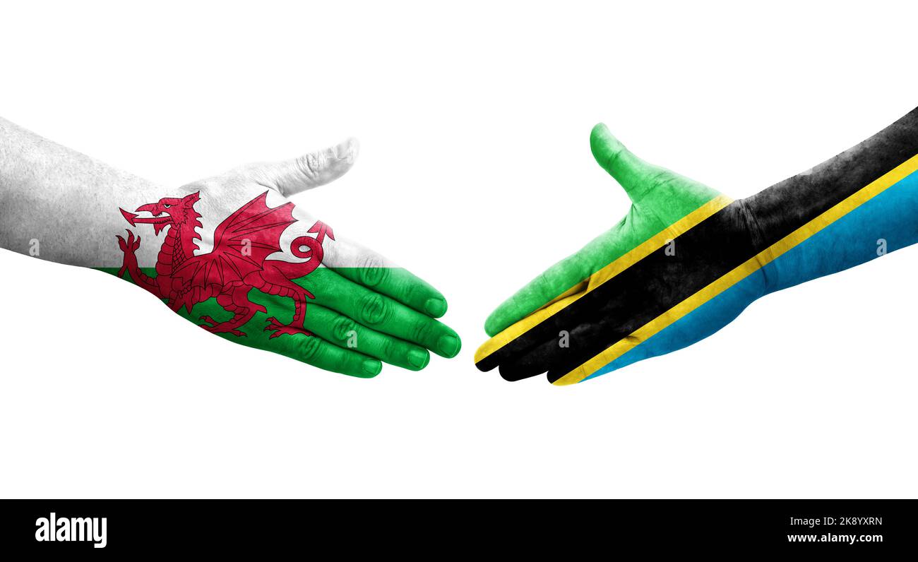 Handshake between Tanzania and Wales flags painted on hands, isolated ...