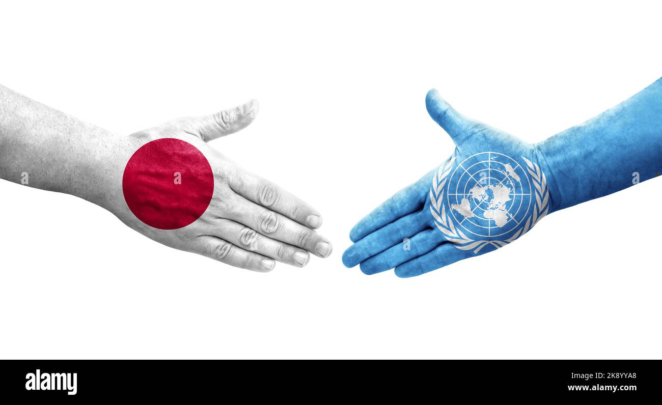 Handshake between United Nations and Japan flags painted on hands ...