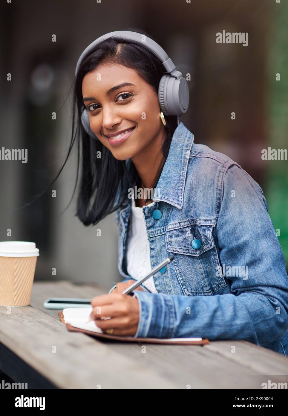 No one ever regrets studying. a young woman making notes while sitting ...