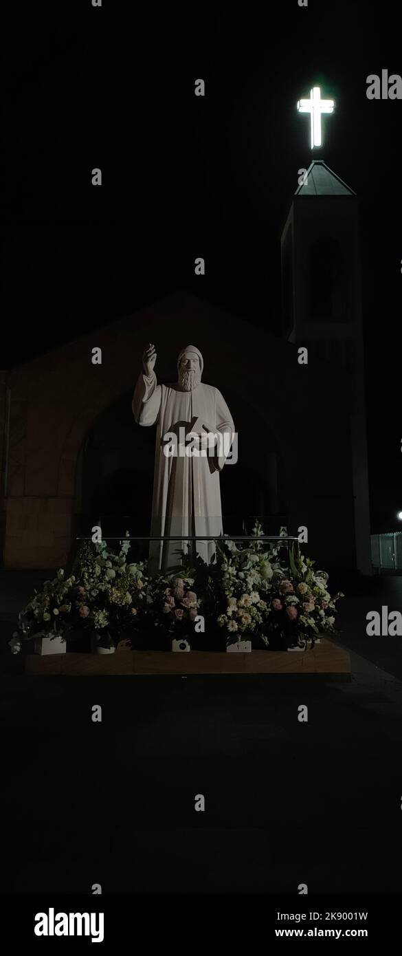 A vertical night view of statue Monastery of Saint Charbel Lebanese ...